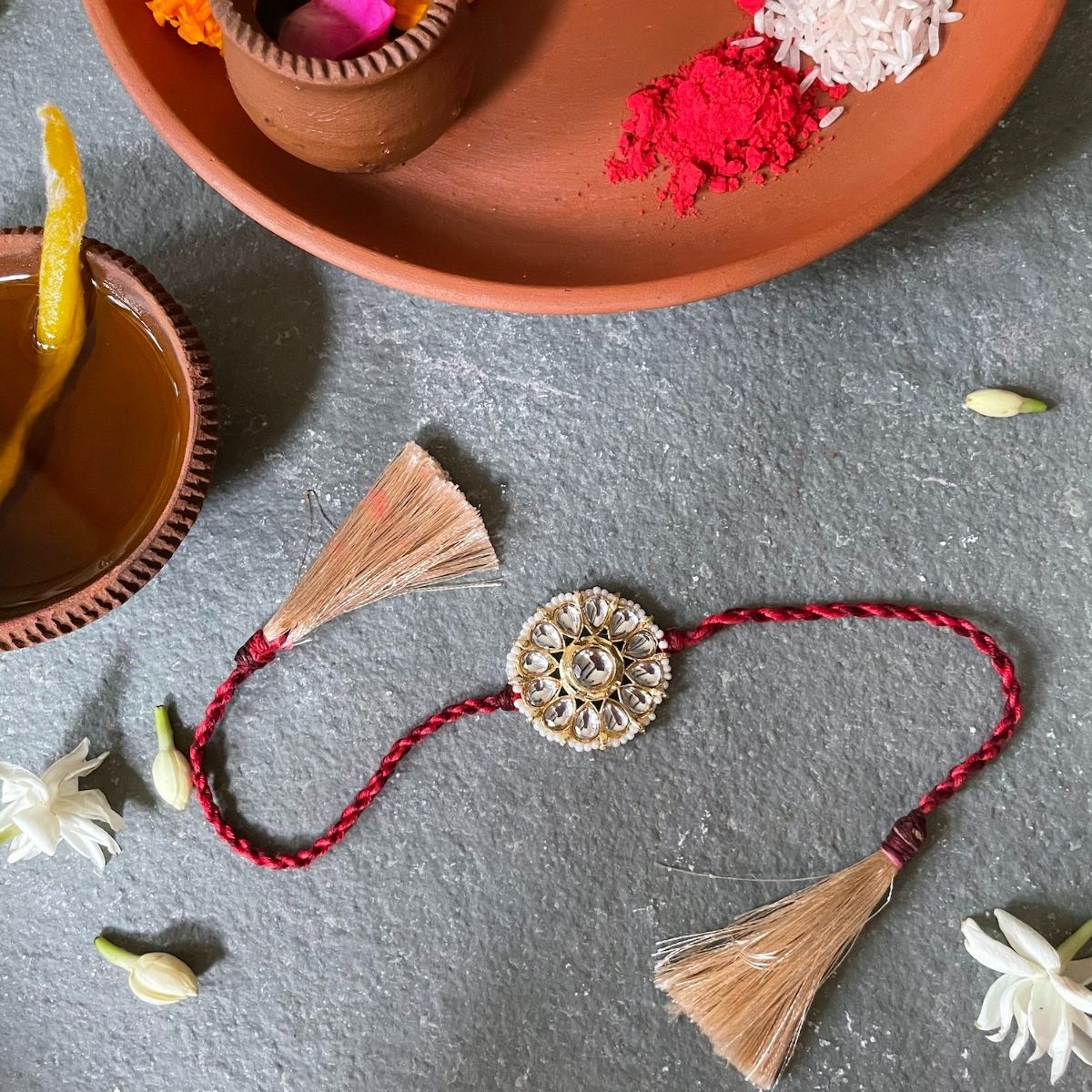 Buy Mitali Jain Kundan Rakhi Golden & Cream With Red Thread Online