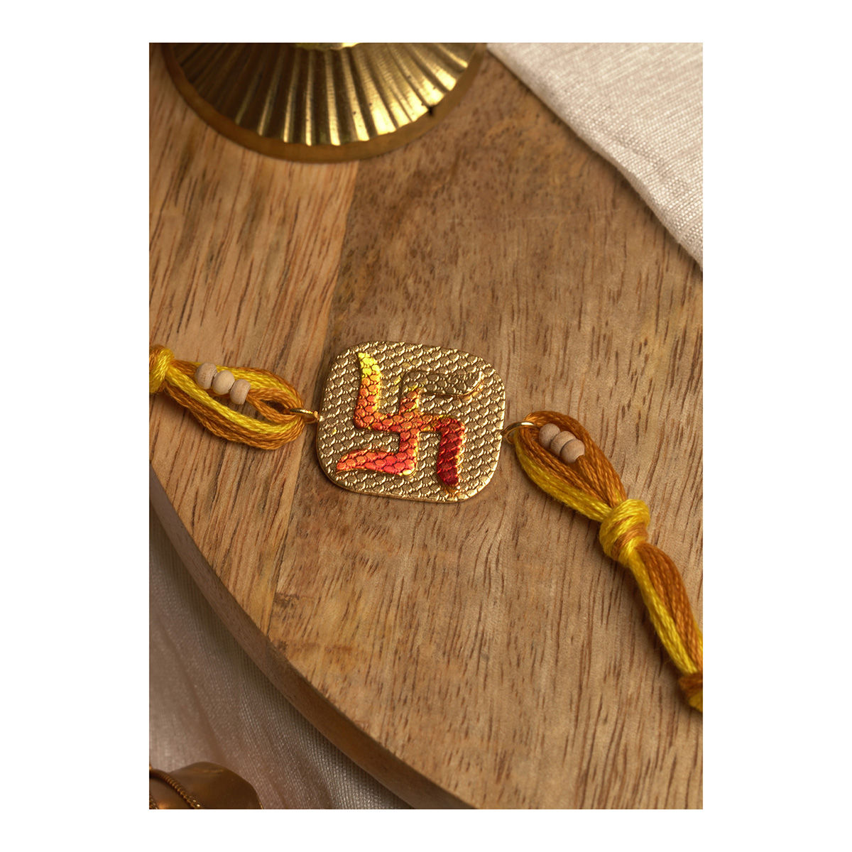 Buy Suhani Pittie Hand Painted Swastik 22K Gold Plated Square Rakhi ...